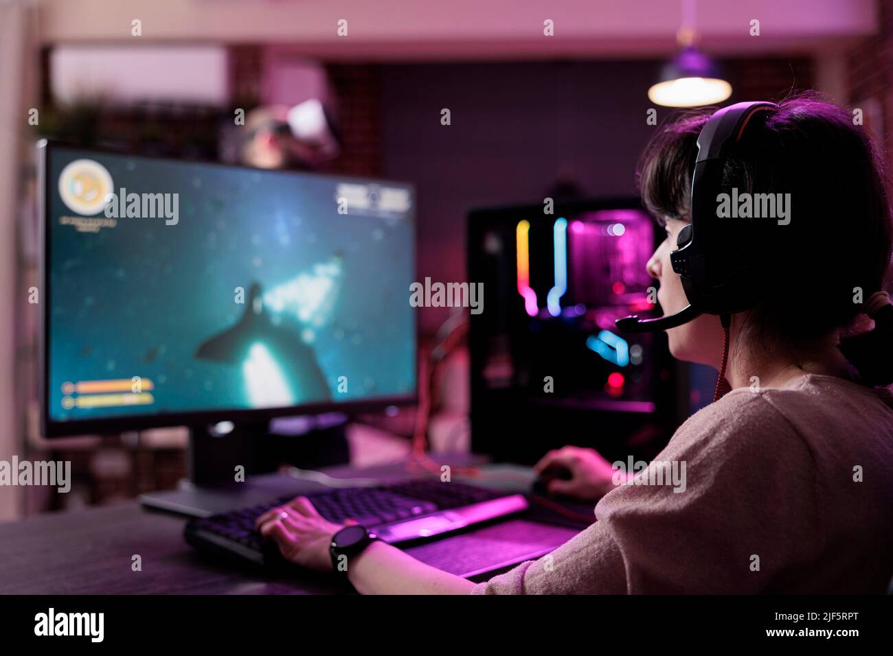 Modern person playing video games online on live stream, using computer ...