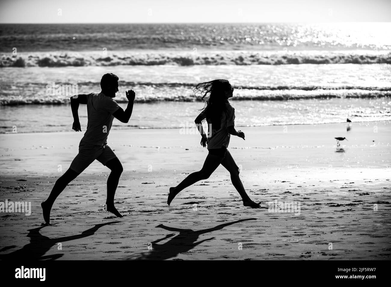Sport and healthy lifestyle, friends jogging at sunset on the beach ...