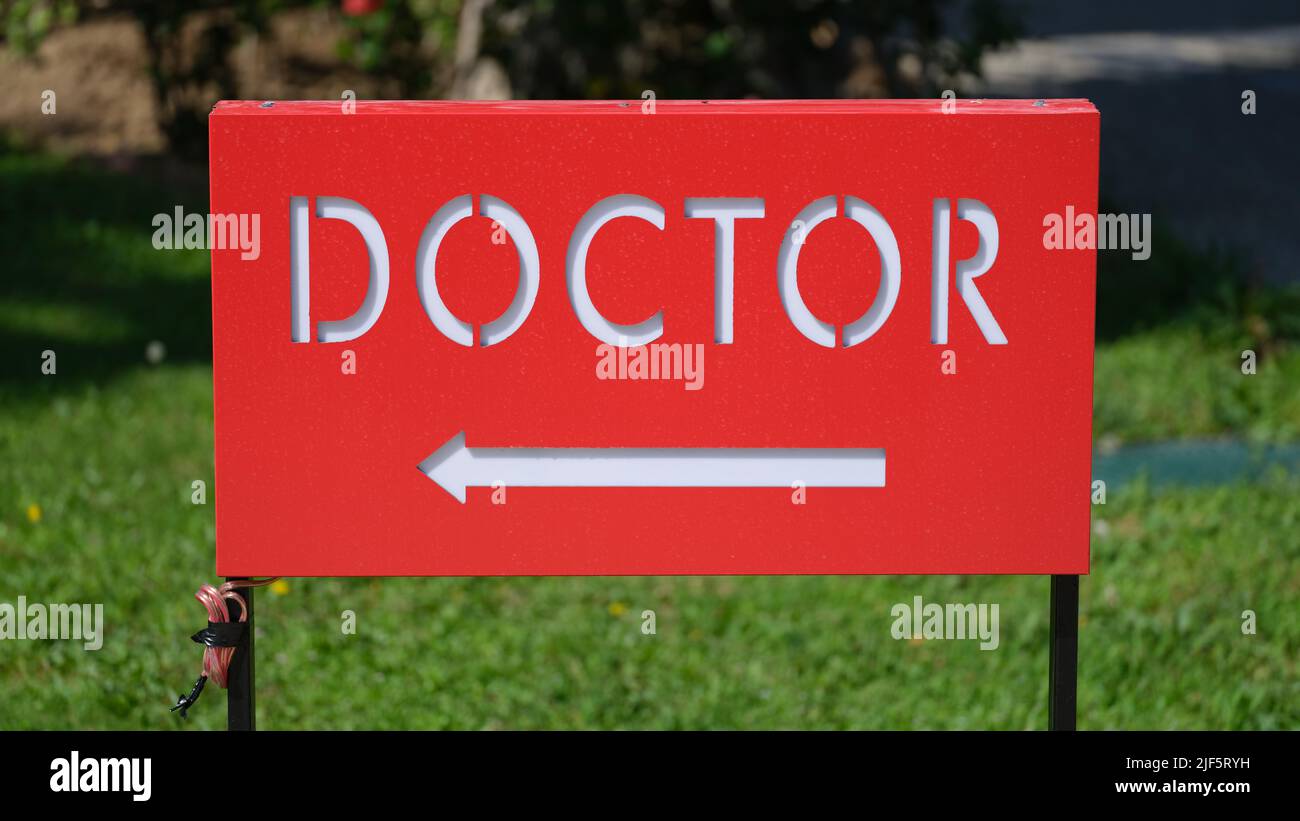 Red table with word doctor and arrow Stock Photo - Alamy