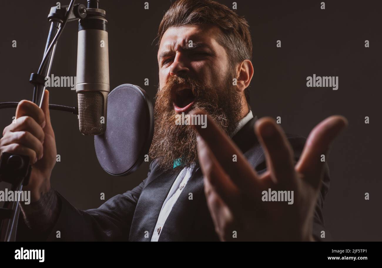 Classic singer in suit. Man singing with music microphone Stock Photo ...