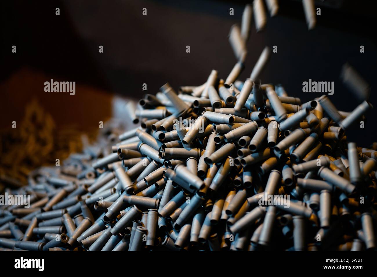 Shell casings fall down in ammunition production workshop Stock Photo ...