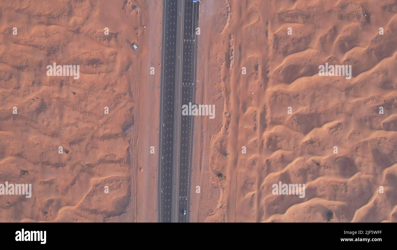 aerial view of sand dunes and a highway in a Sharjah desert, UAE ...