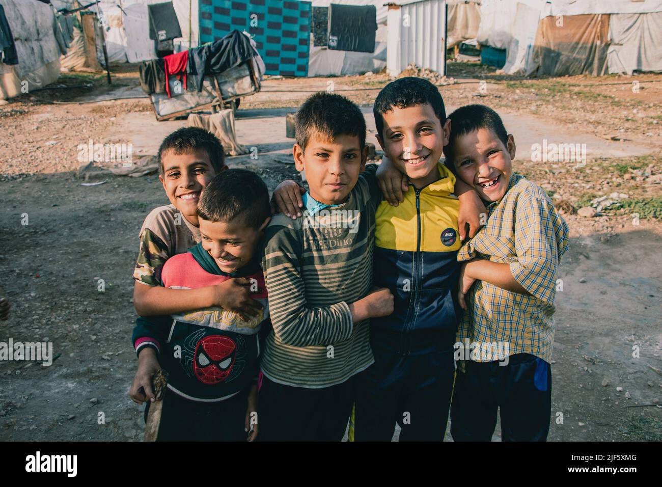 Syrian boys are playing together in the camp. This informal refugee ...