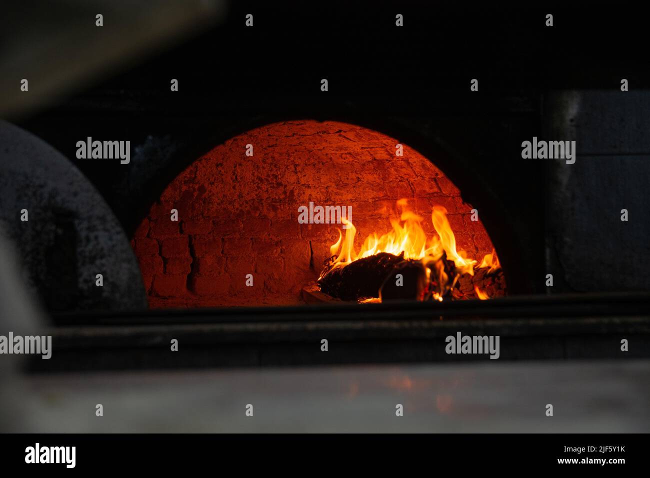 Traditional stone oven with burning wood inside. Oven for cooking ...