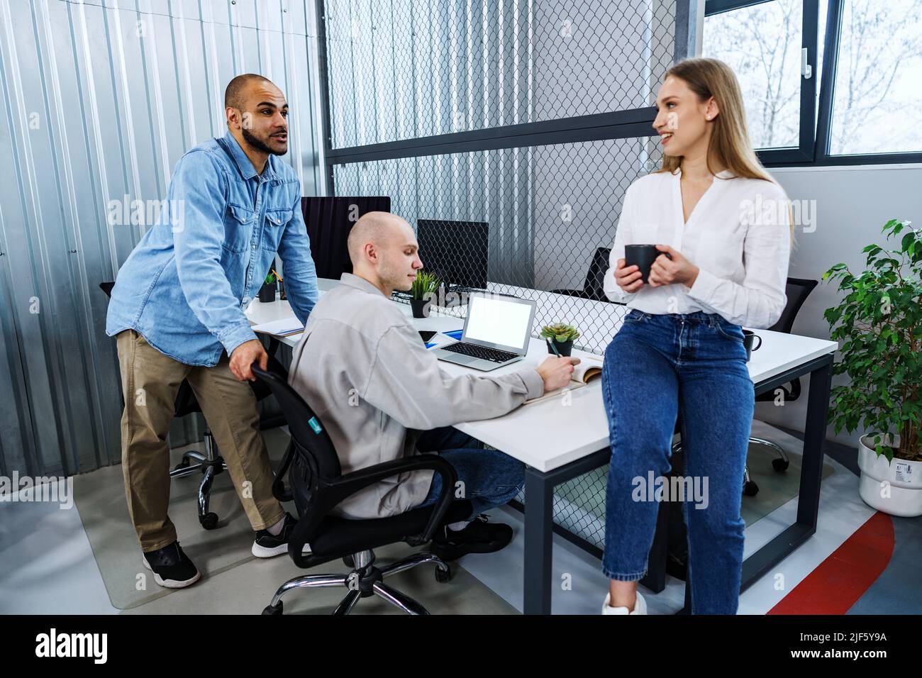 Group of young business people working in office together Stock Photo ...