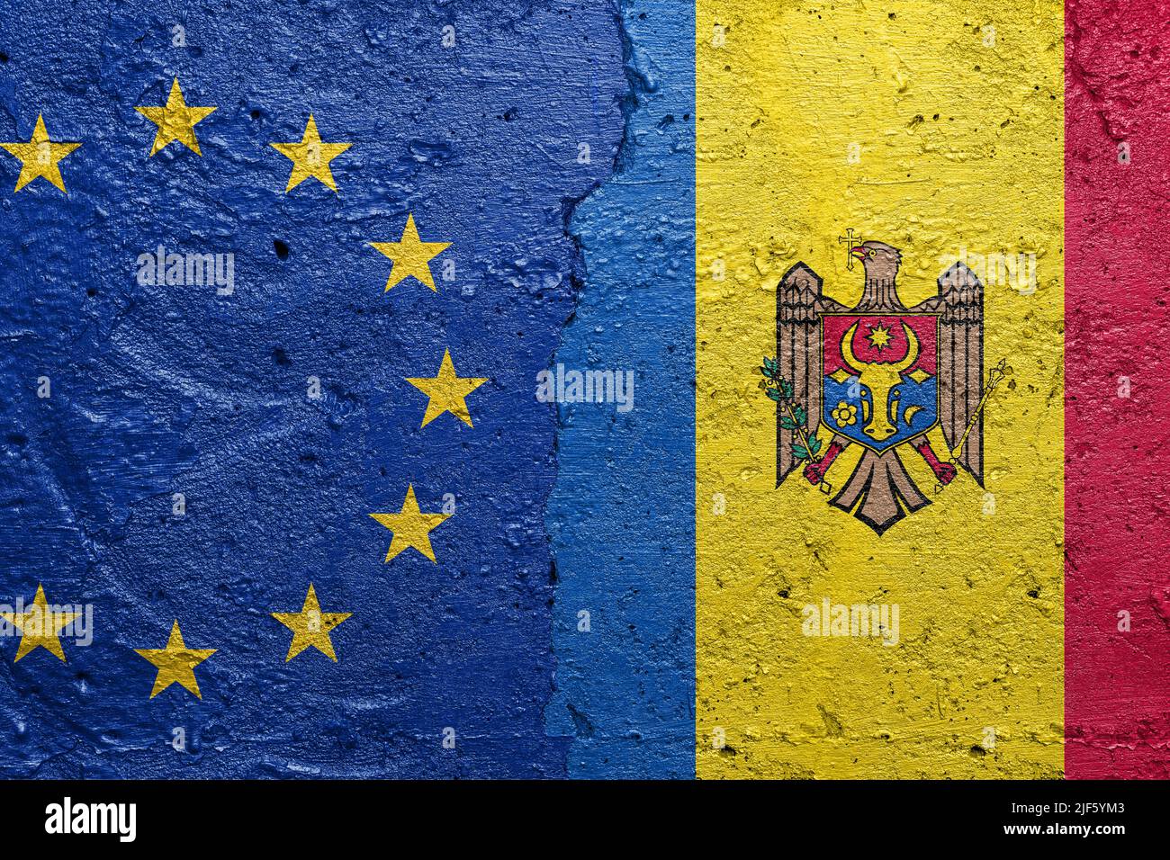 European Union and Moldova flags - Cracked concrete wall painted with a ...