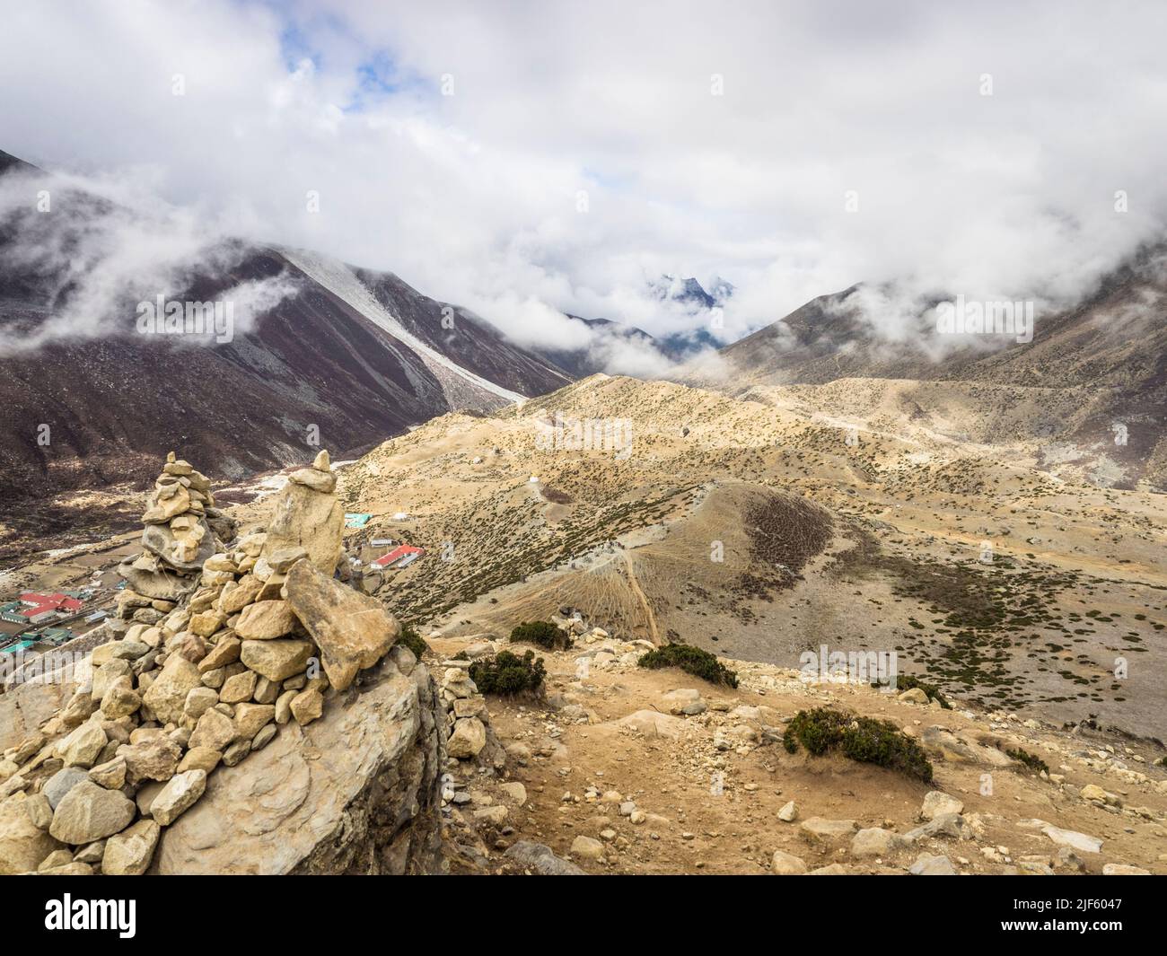 Cairns show the way on the barren ridge leading to Nangkartshang Peak ...