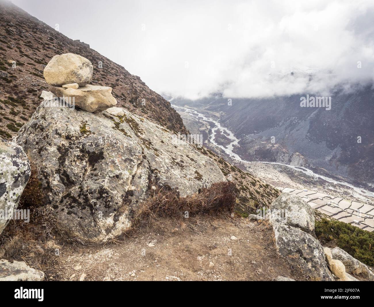Rock cairn on a boulder T 4600m on the ridge leading to Nangkartshang ...
