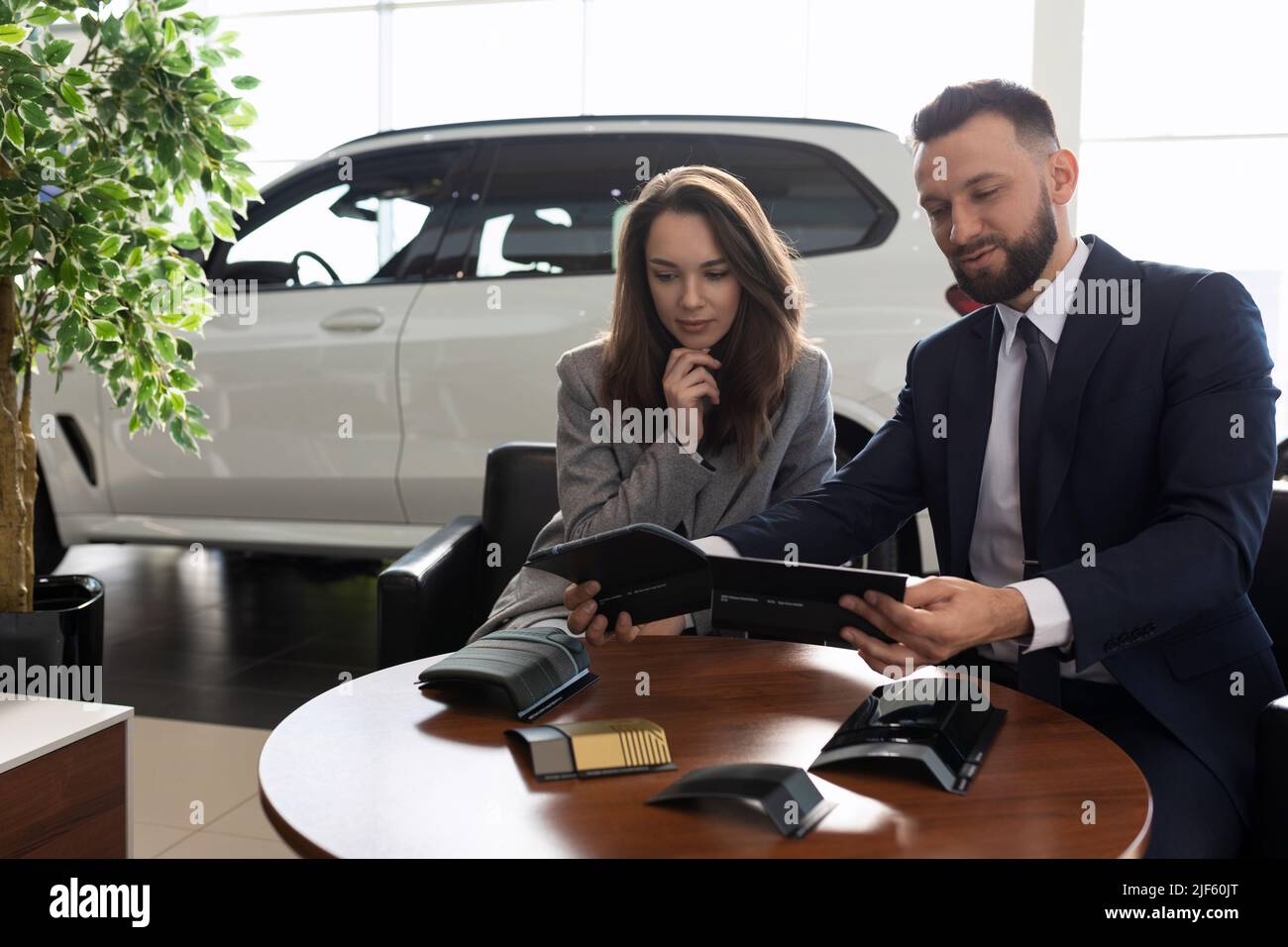 car dealership manager offers a young woman when buying a car different ...