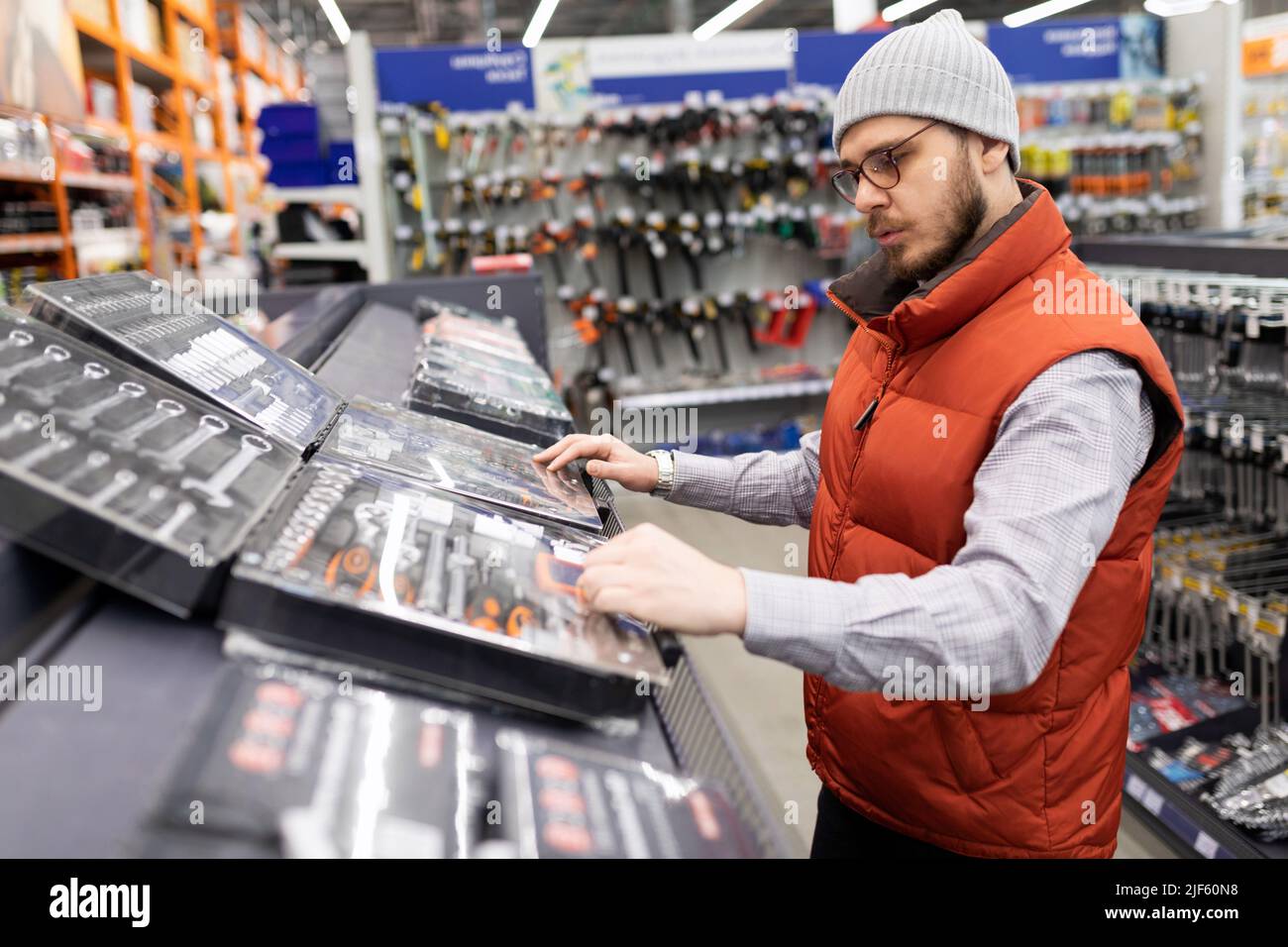 a man chooses a set of sockets to repair his car in a tool store Stock ...