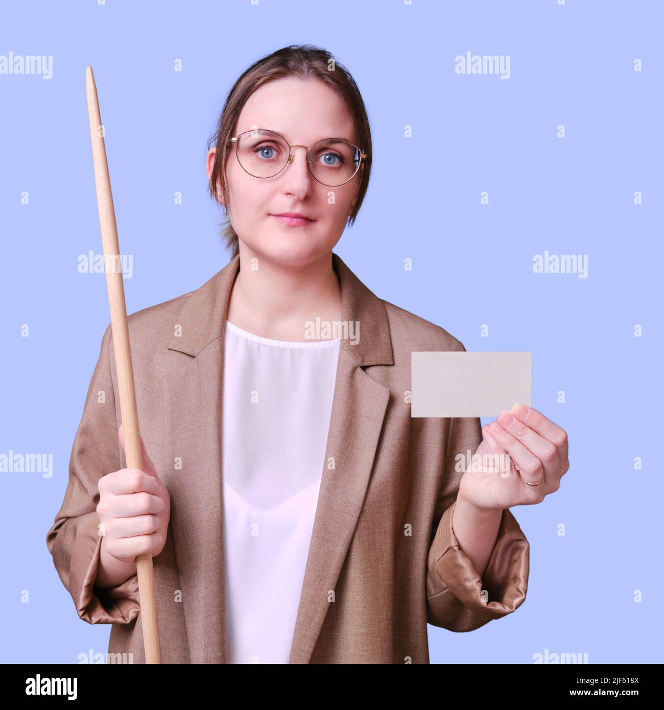 Happy woman teacher holding business card on studio blue background ...