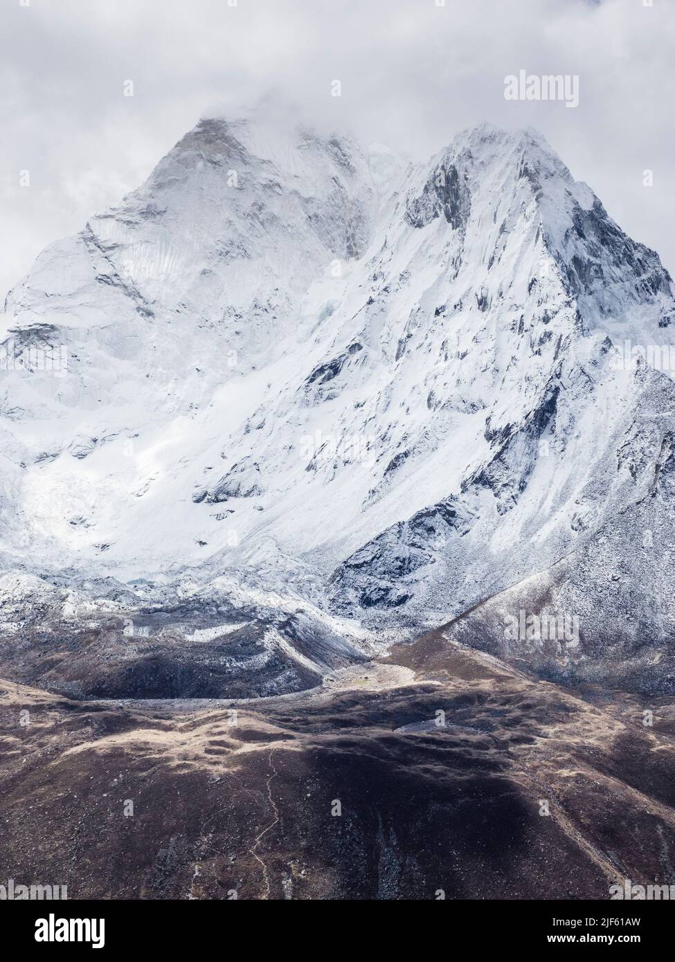 West Face of Ama Dablam (6856m) surrounded by May clouds above the Imja ...