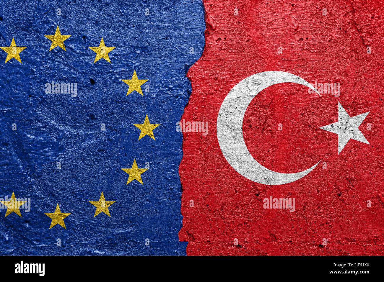 European Union and Turkey flags - Cracked concrete wall painted with a ...