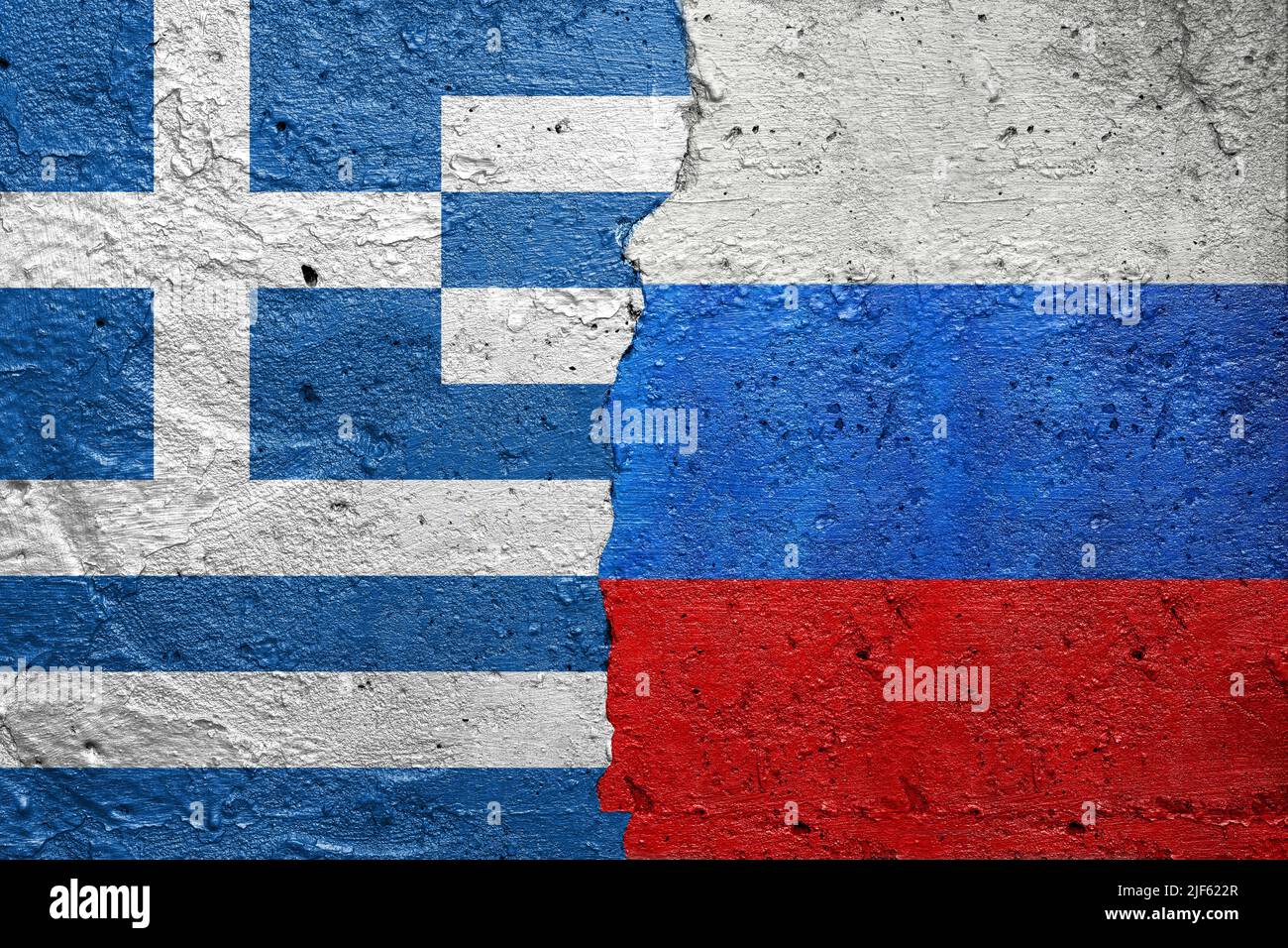 Greece and Russia - Cracked concrete wall painted with a Greek flag on ...