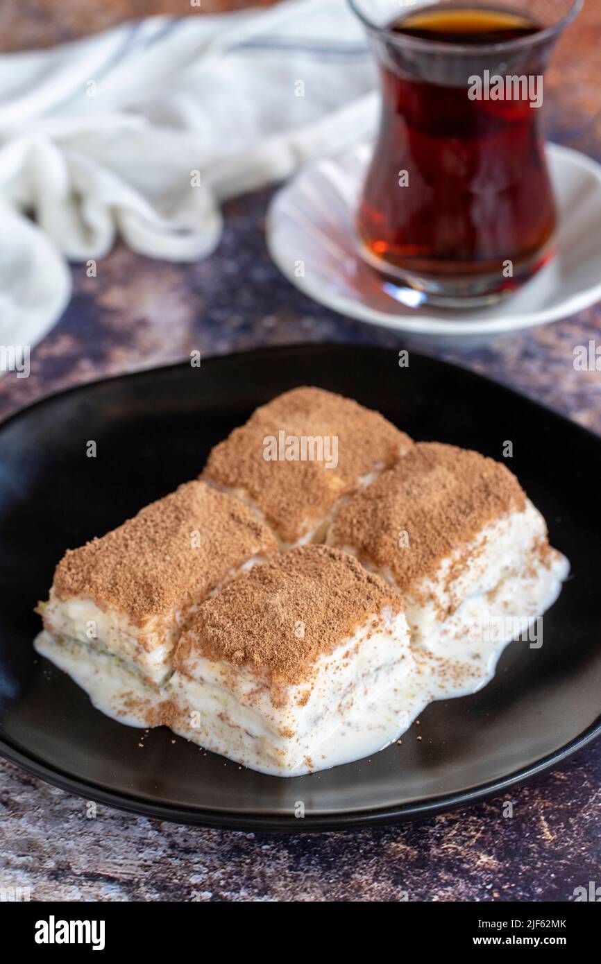 Cold baklava. Baklava with milk on a colored background. Turkish ...