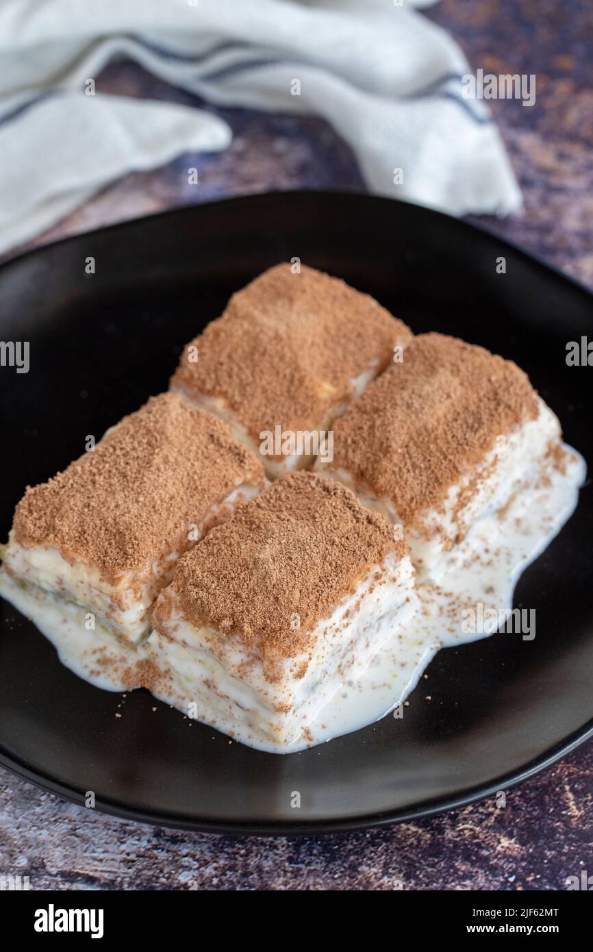 Cold baklava. Baklava with milk on a colored background. Turkish ...