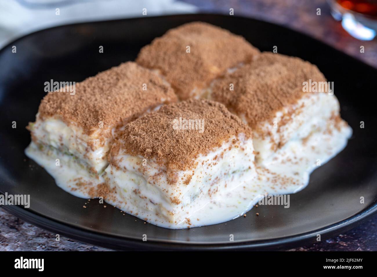 Cold baklava. Baklava with milk on a colored background. Turkish ...