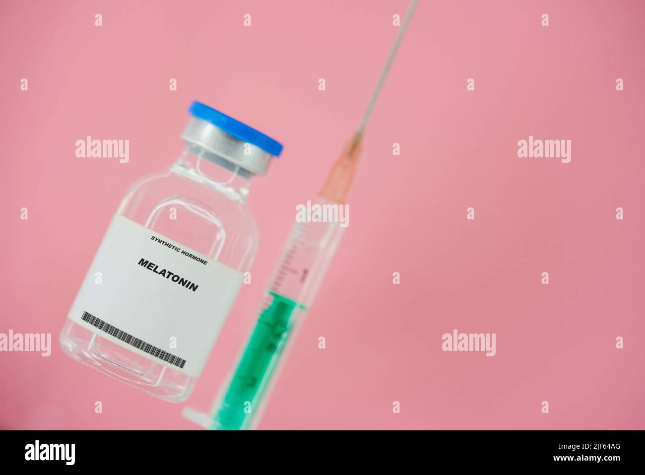 Melatonin. Test tube with artificial hormone on pink background ...