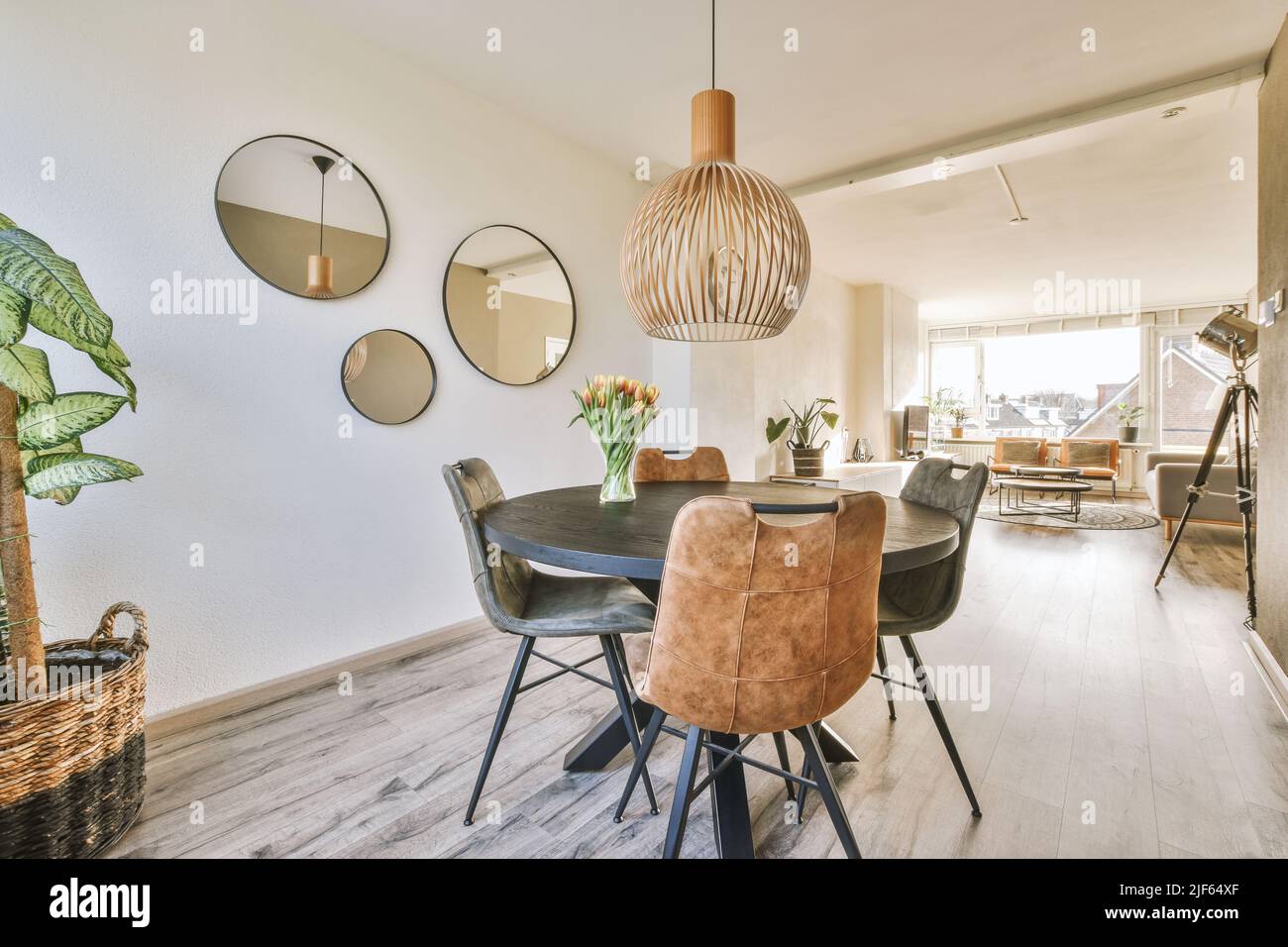 Simple interior of light living room with gray sofa in front of TV and ...