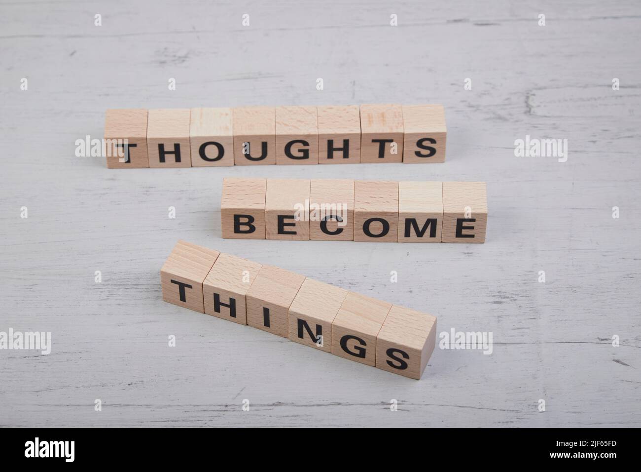 wooden cubes showing the words thoughts become things Stock Photo - Alamy