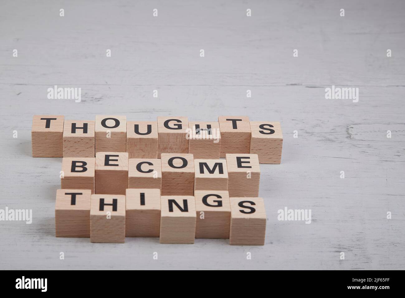 wooden cubes showing the words thoughts become things Stock Photo - Alamy
