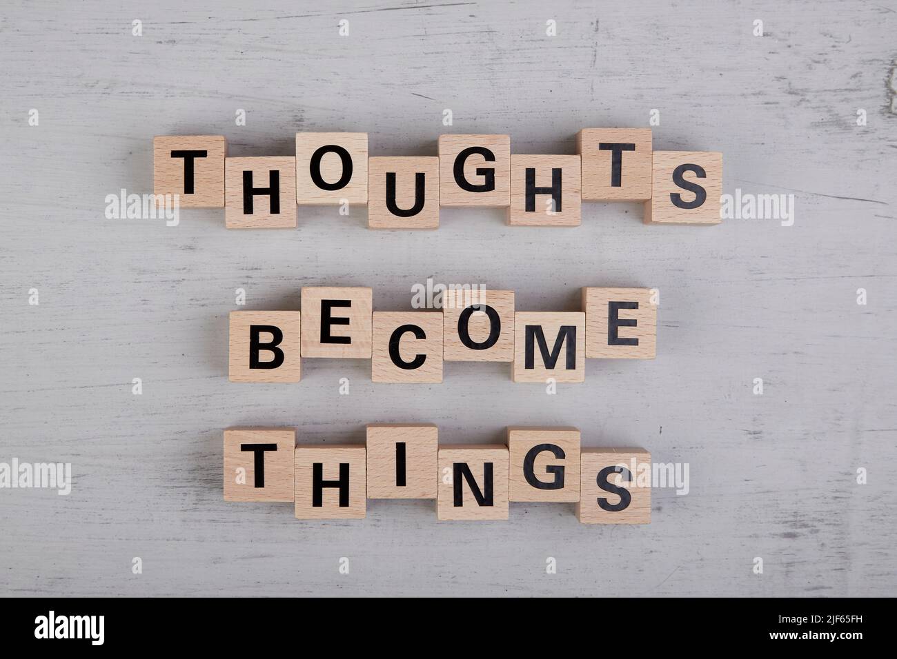 wooden cubes showing the words thoughts become things Stock Photo - Alamy