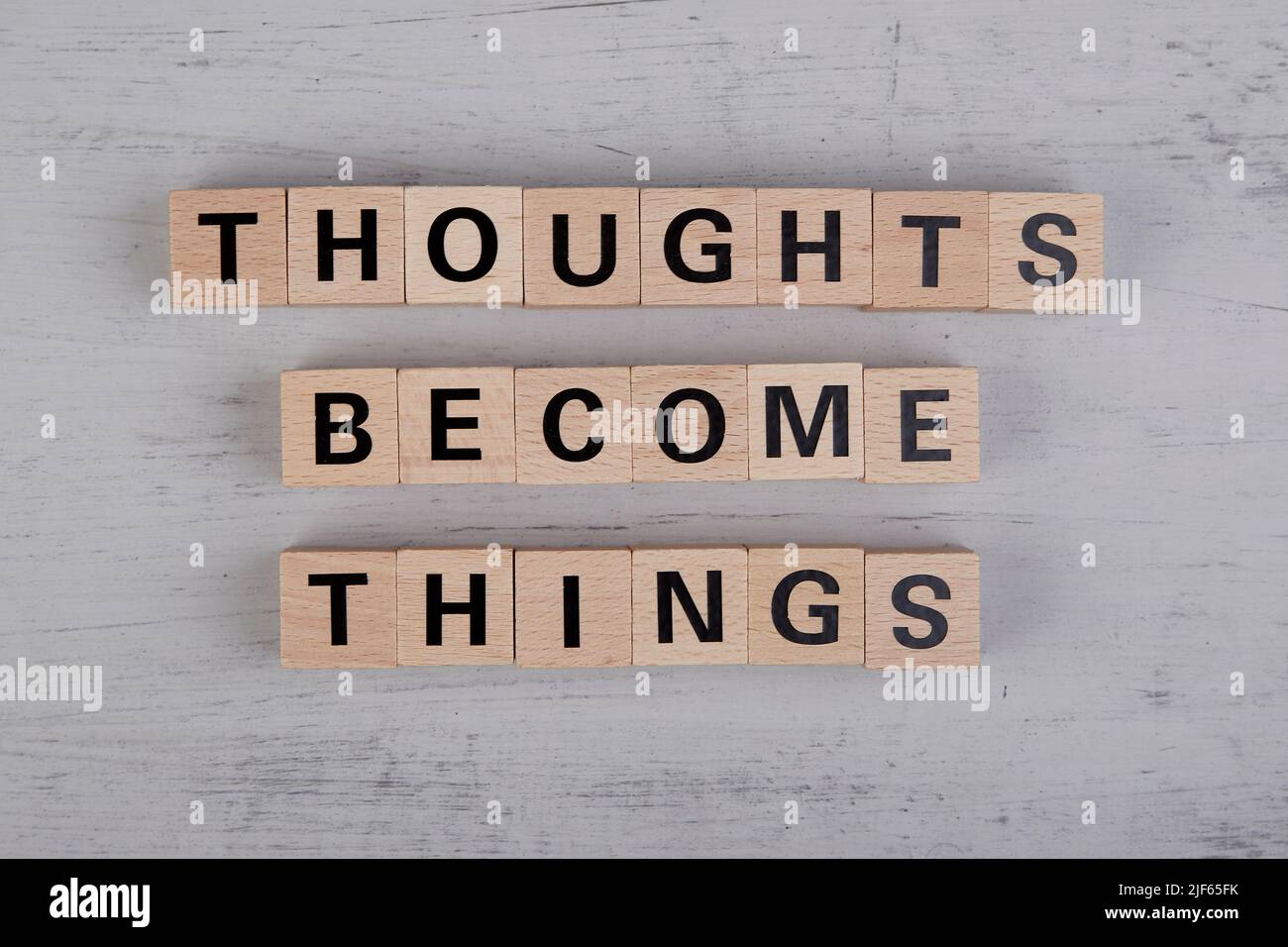 wooden cubes showing the words thoughts become things Stock Photo - Alamy