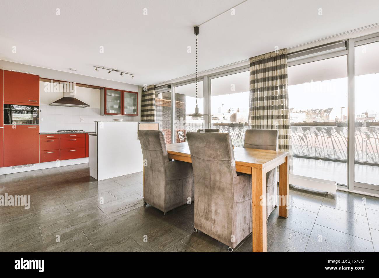 Counters with stove and oven located in modern kitchen near dining room ...