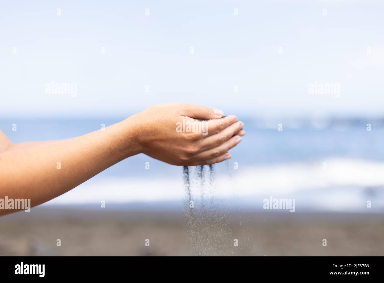 Female hands with sand. Summer holidays and vacation concept. Close up ...