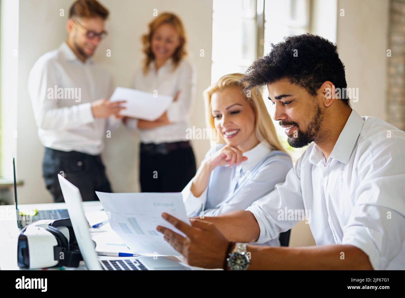 Group of happy multiethnic business people cooperating, working on ...
