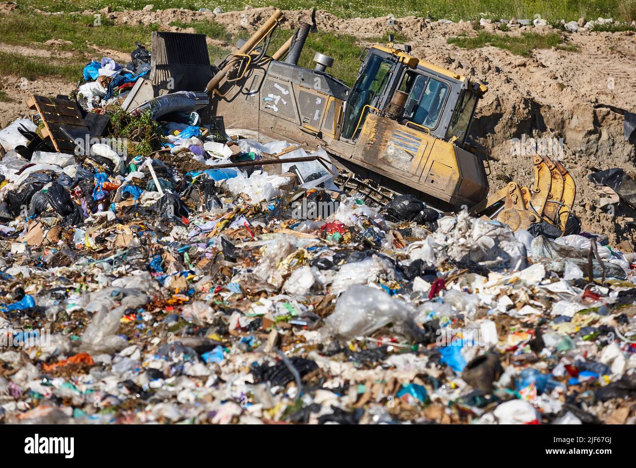 Heavy machinery shredding garbage in an open air landfill. Waste Stock ...
