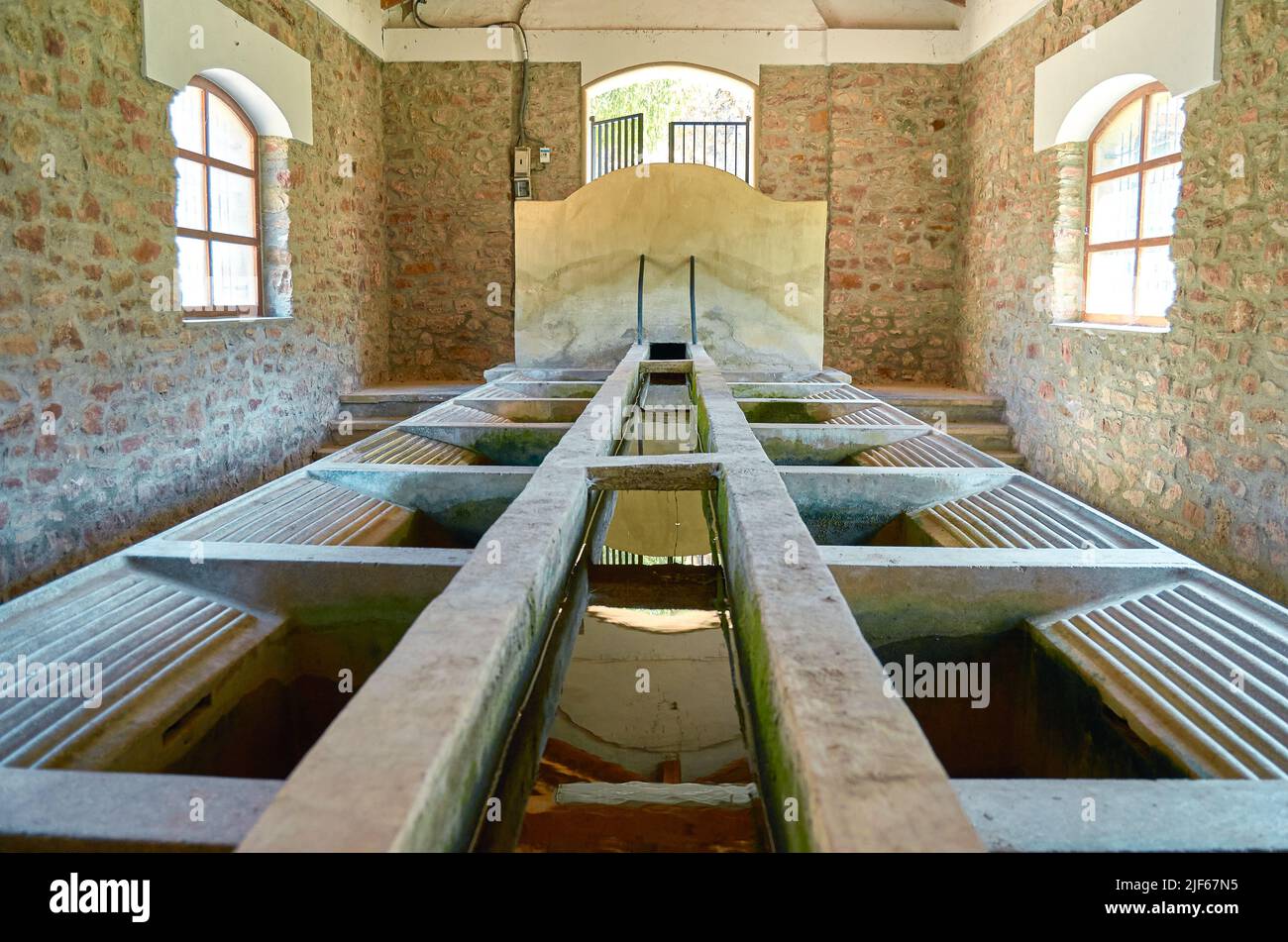 Covered old stone wash house Stock Photo - Alamy