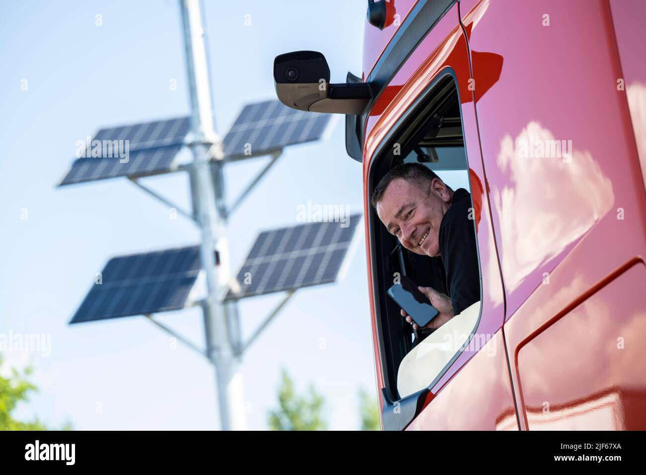 Medenbach, Germany. 30th June, 2022. A truck driver looks out of his ...