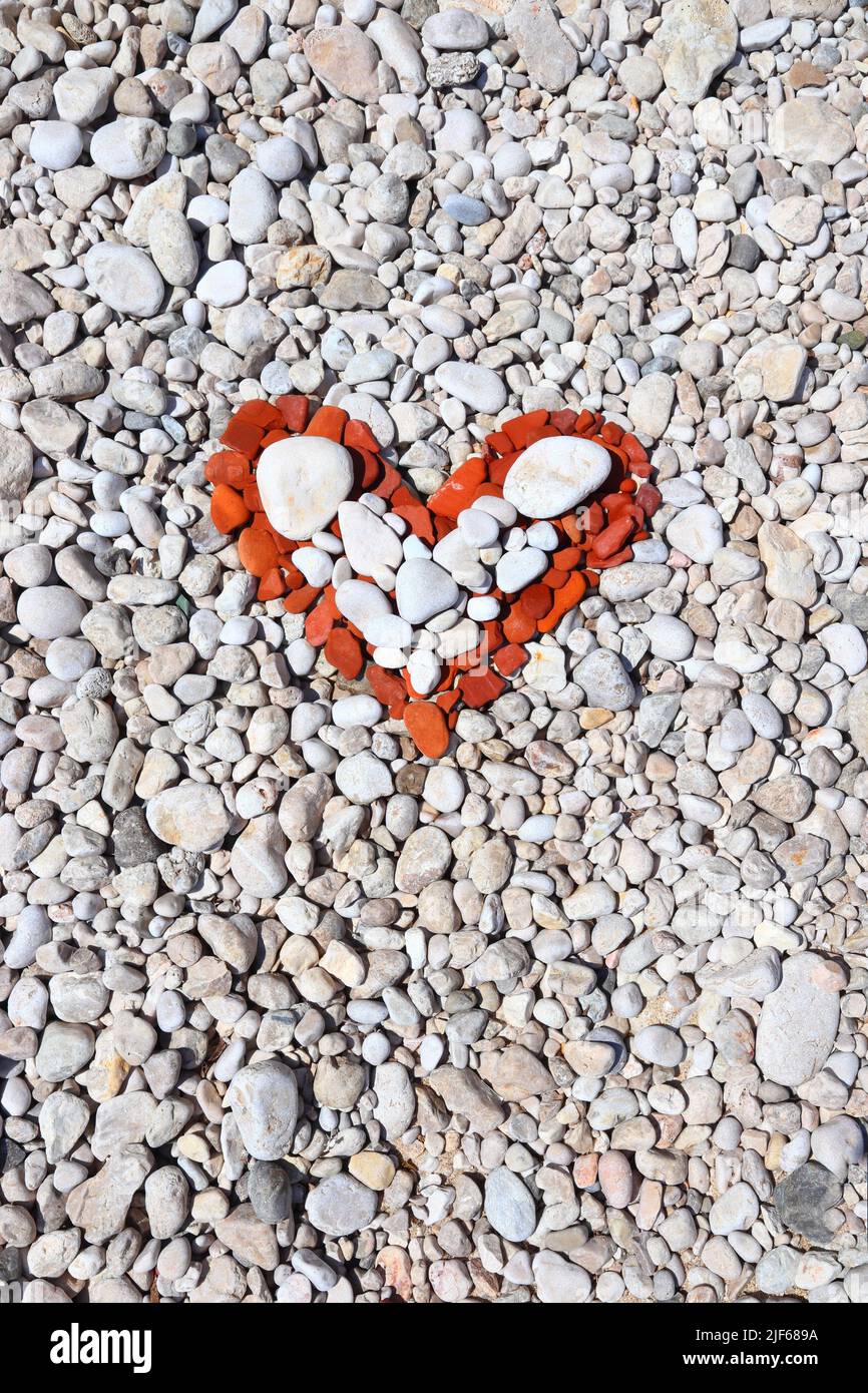 Red heart shape made of beach stones and pebbles. Valentine's Day ...