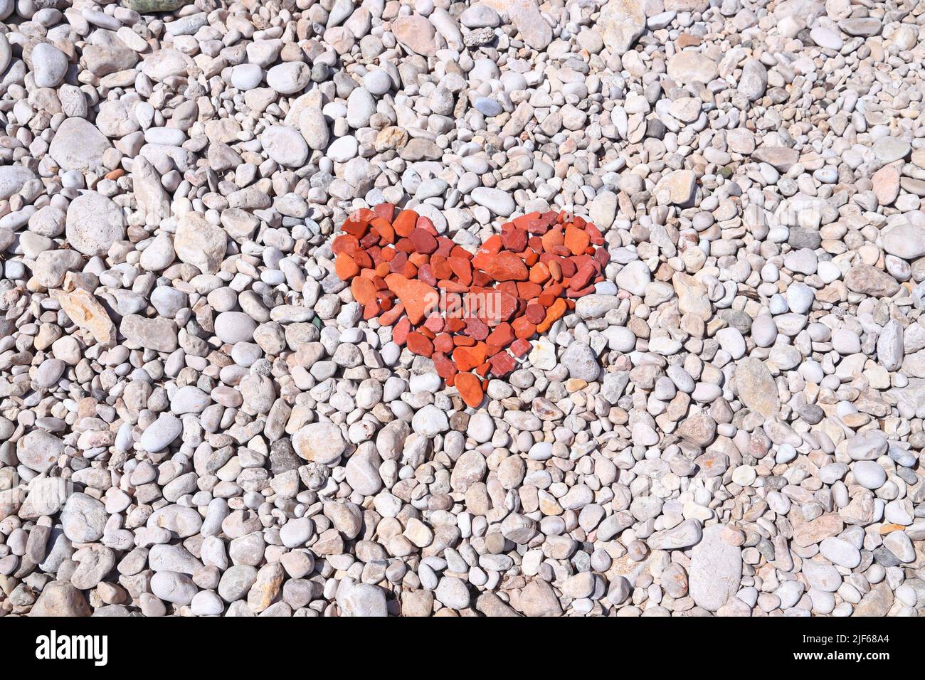 Red heart shape made of beach stones and pebbles. Valentine's Day ...