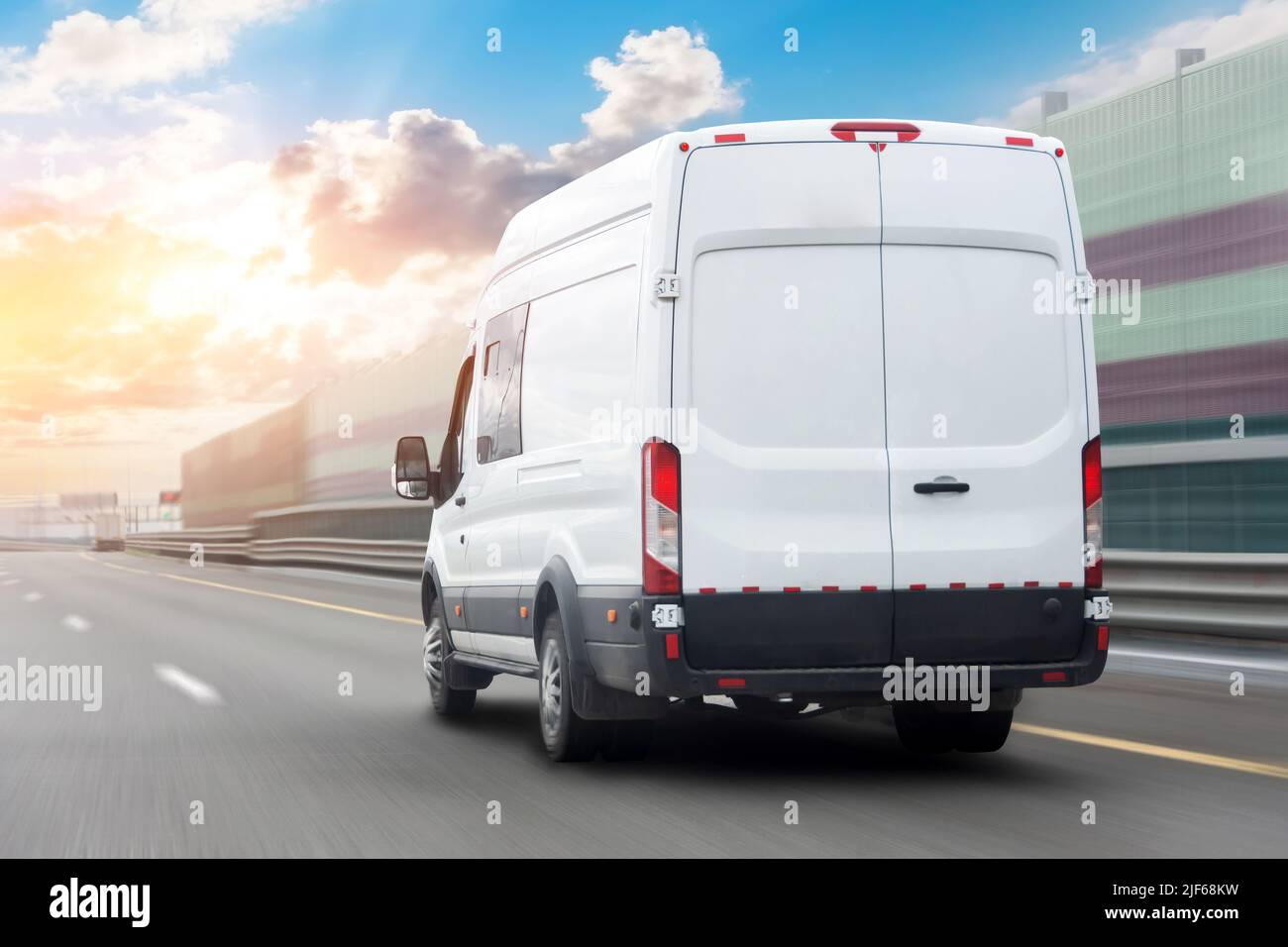 White mini bus is moving motion blur along city highway bypass road ...