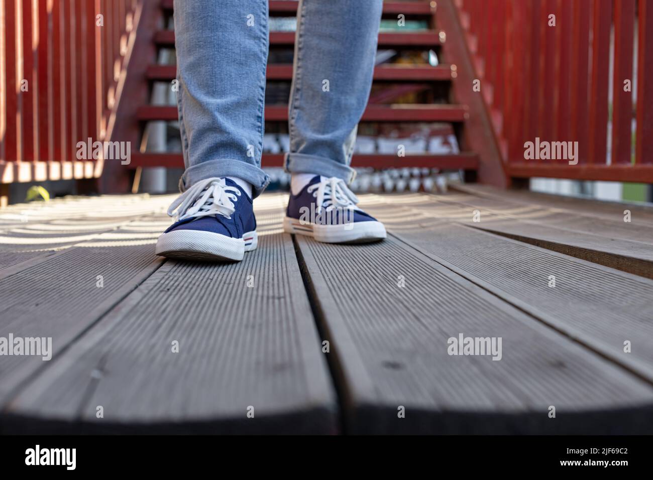 feet in sneakers walk along the boardwalk. High quality photo Stock Photo - Alamy