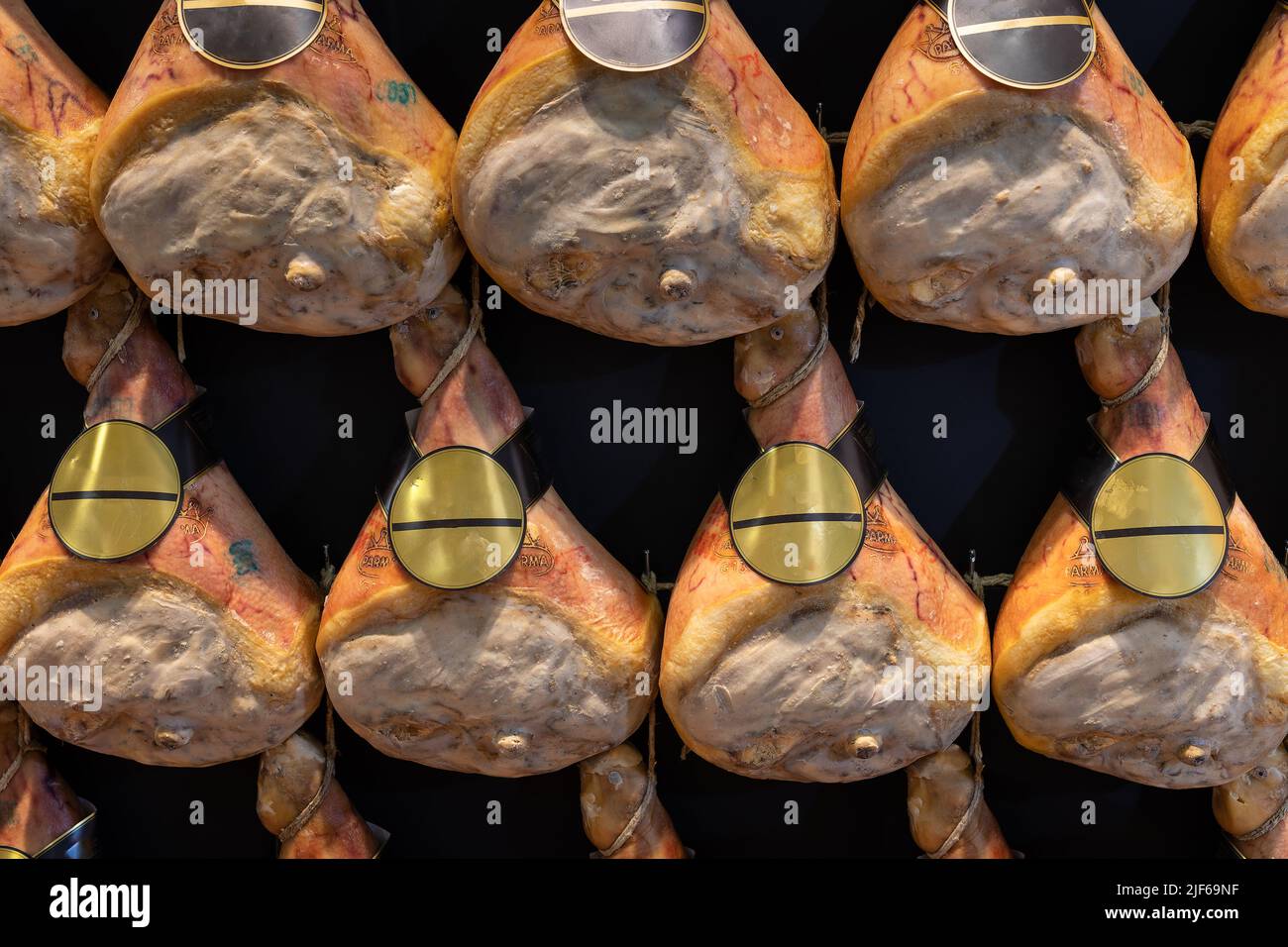 Group of Whole Raw Hams hung on a Wall Stock Photo - Alamy