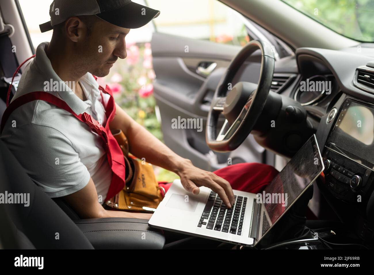 Mechanic man close up using laptop computer examining tuning fixing ...