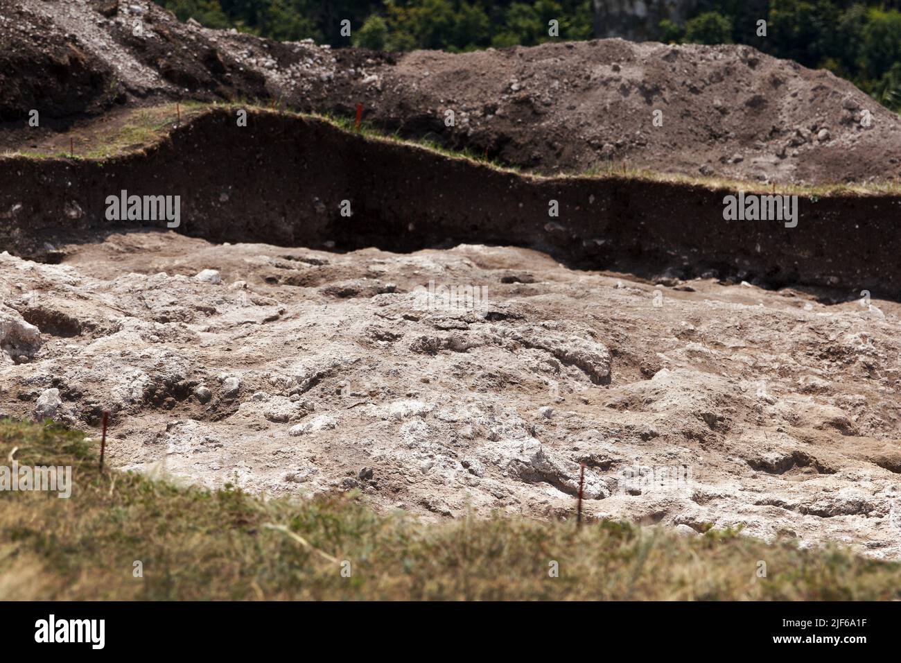 Rocky bottom of an archaeological pit dug on a hillside in search of ...