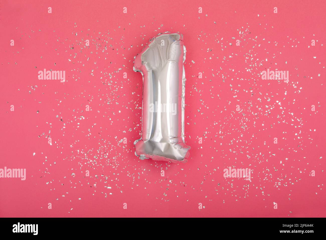 Silver balloon in shape of number one 1 pink background Stock Photo - Alamy