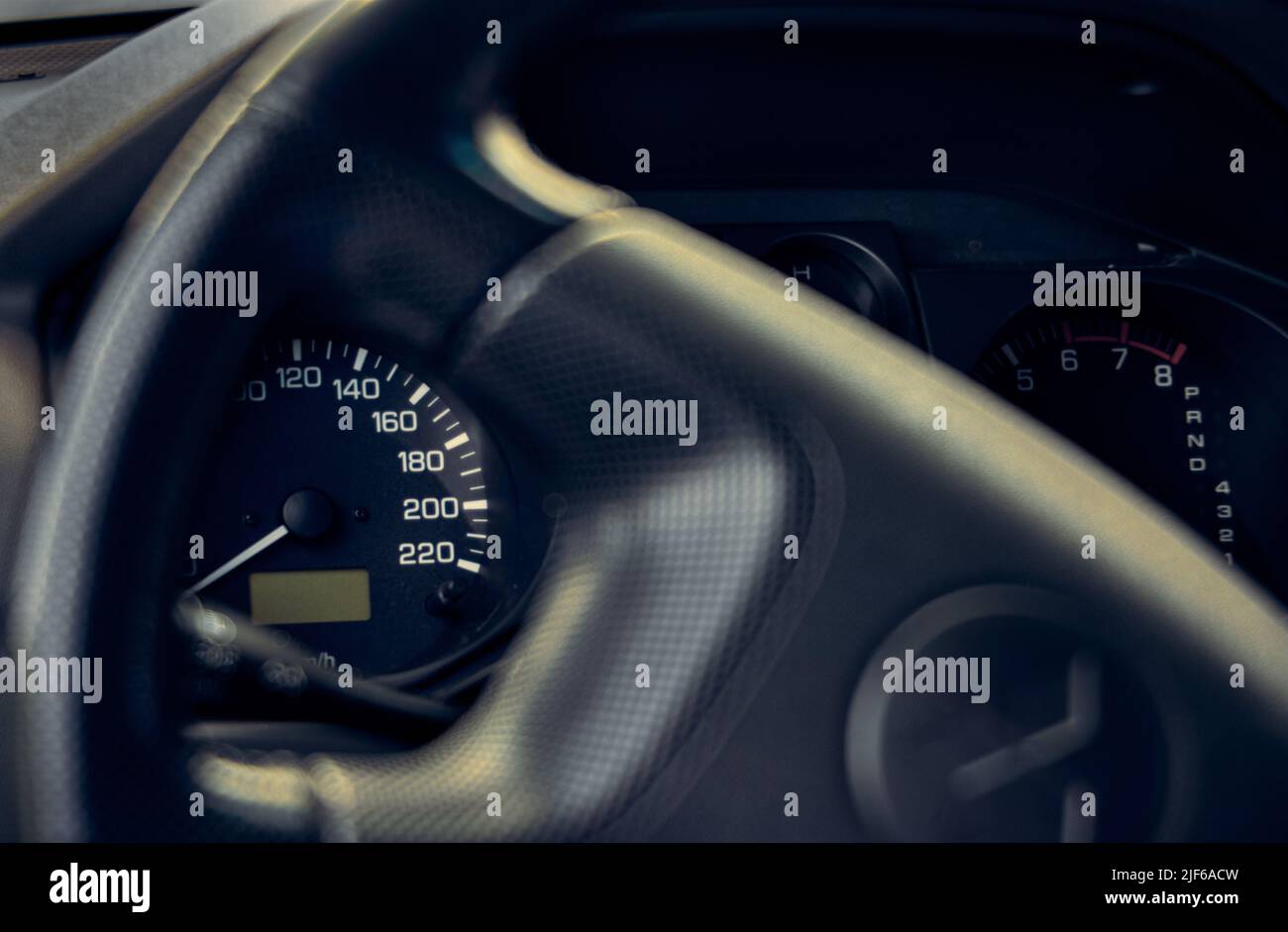 Closeup photo of car speedometer and steering wheel Stock Photo - Alamy