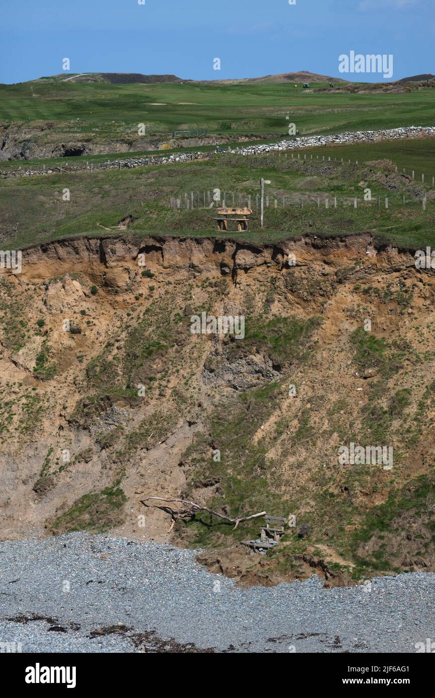 Two benches at the top and bottom of a cliff near Porth Dinllaen on the ...