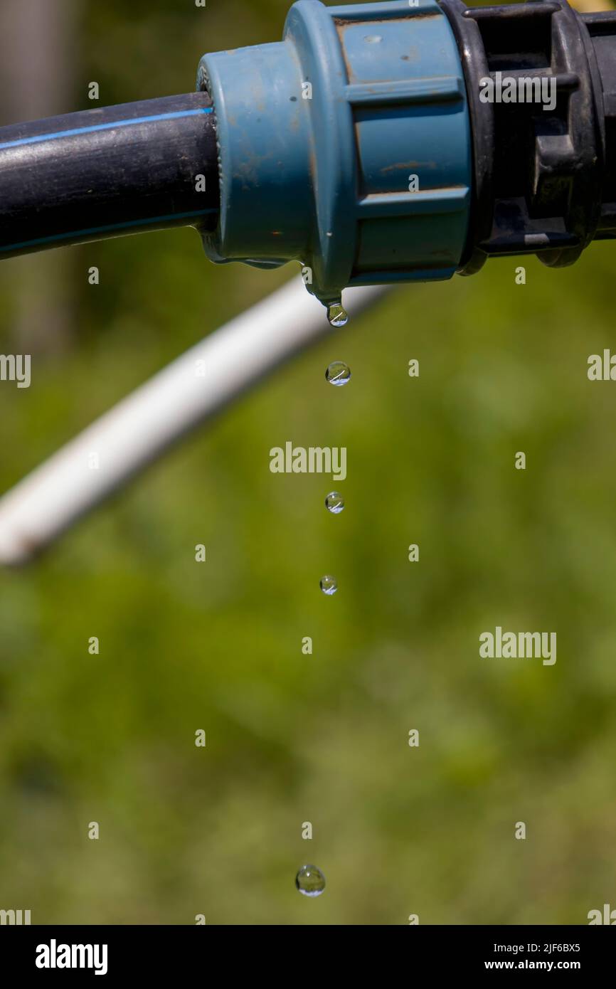 Drops of water falling from the pipe Stock Photo - Alamy