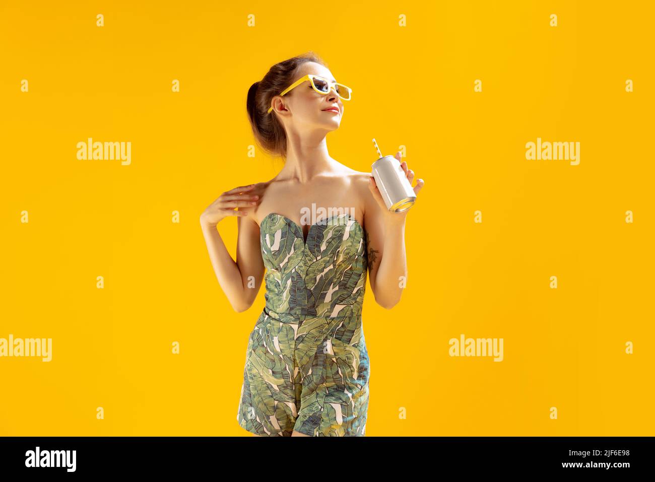 Portrait of beautiful young girl in sunglasses, drinking coke, posing ...