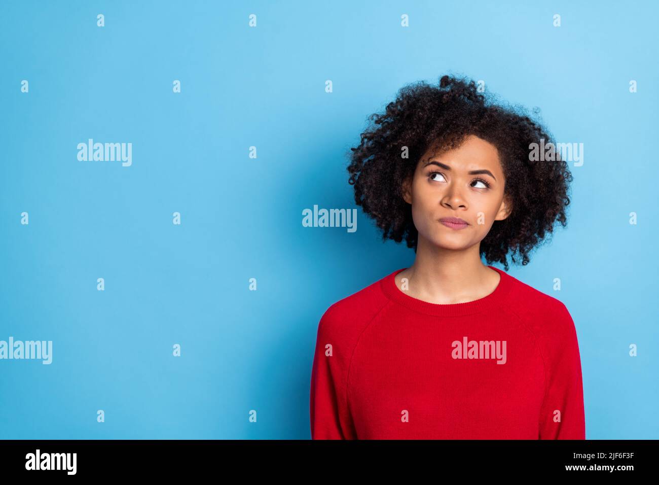 Photo of doubtful unsure lady dressed red pullover looking empty space ...