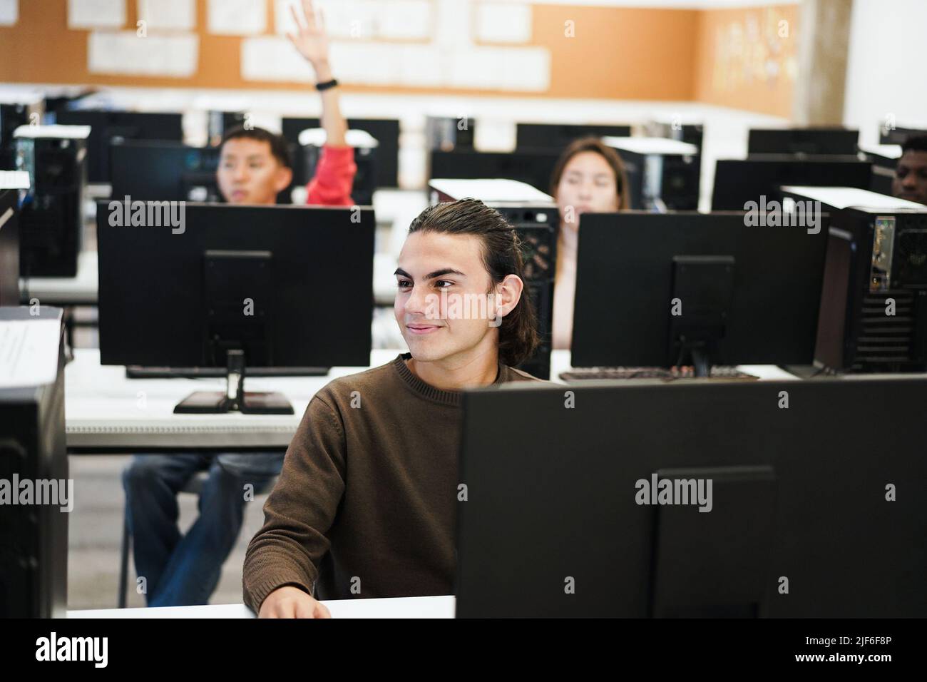 Young students using computers hi-res stock photography and images - Alamy