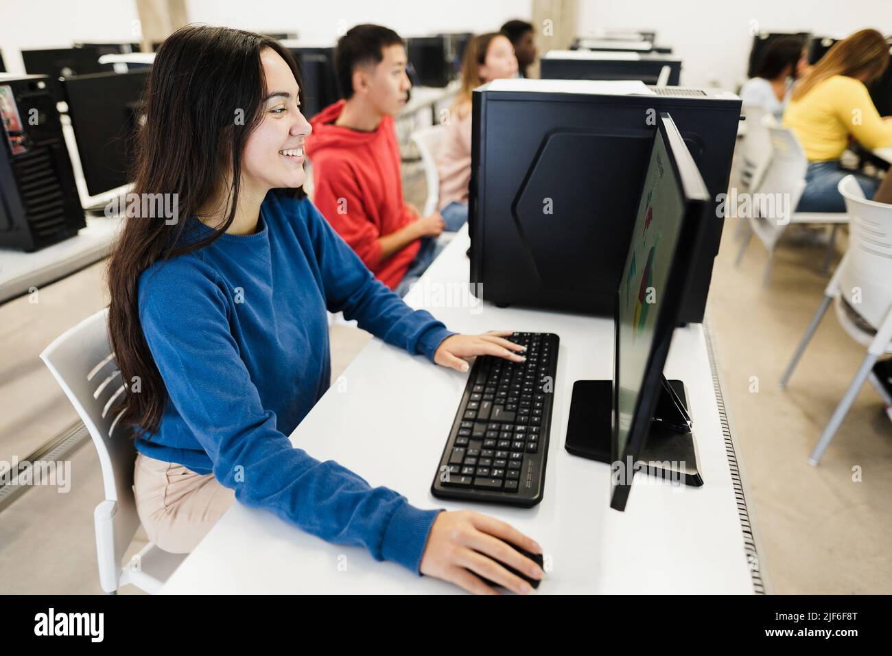 Young students using computers during business class at school - Focus ...