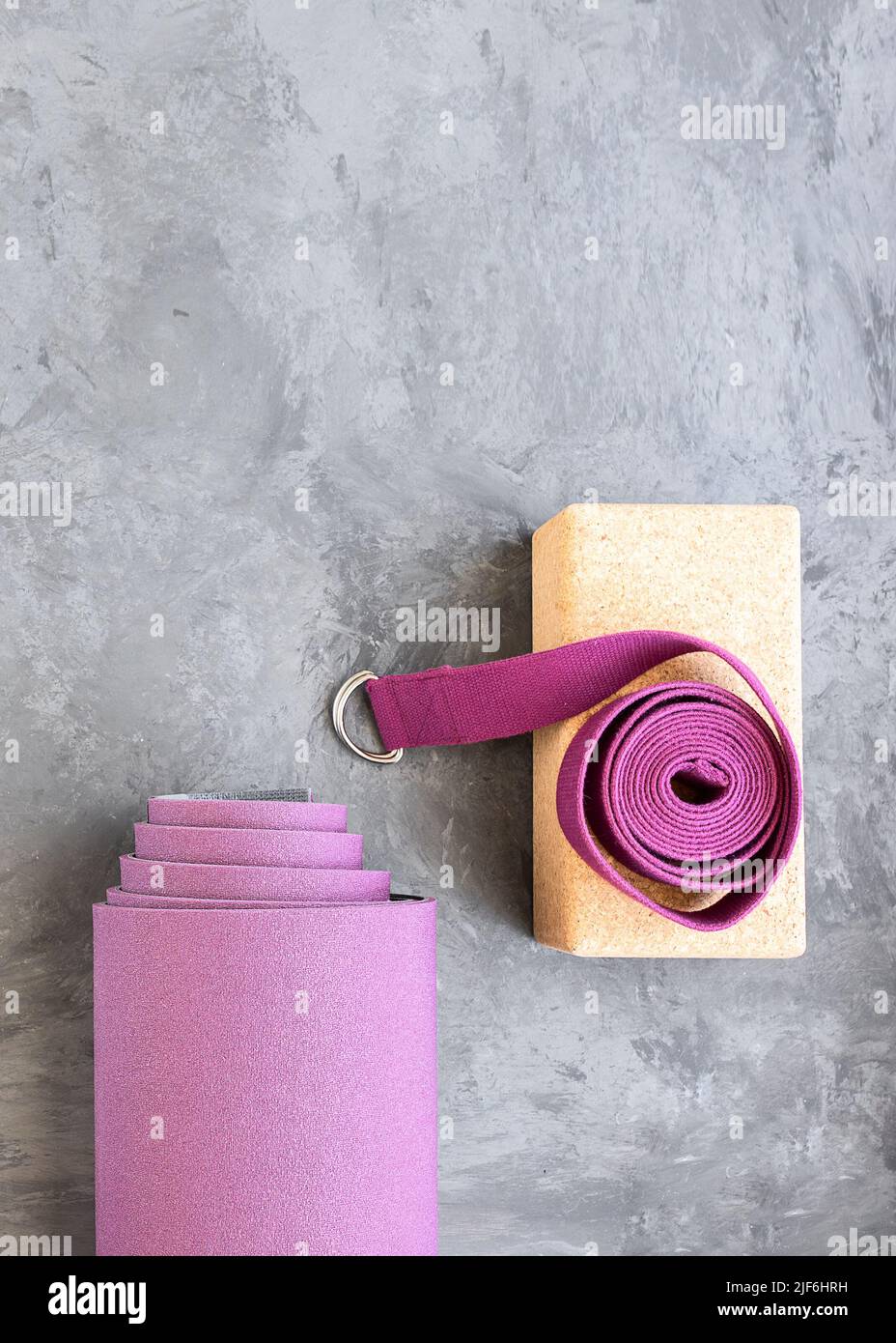 Rolled yoga mat with cork block and yoga belt. Yoga practice props ...