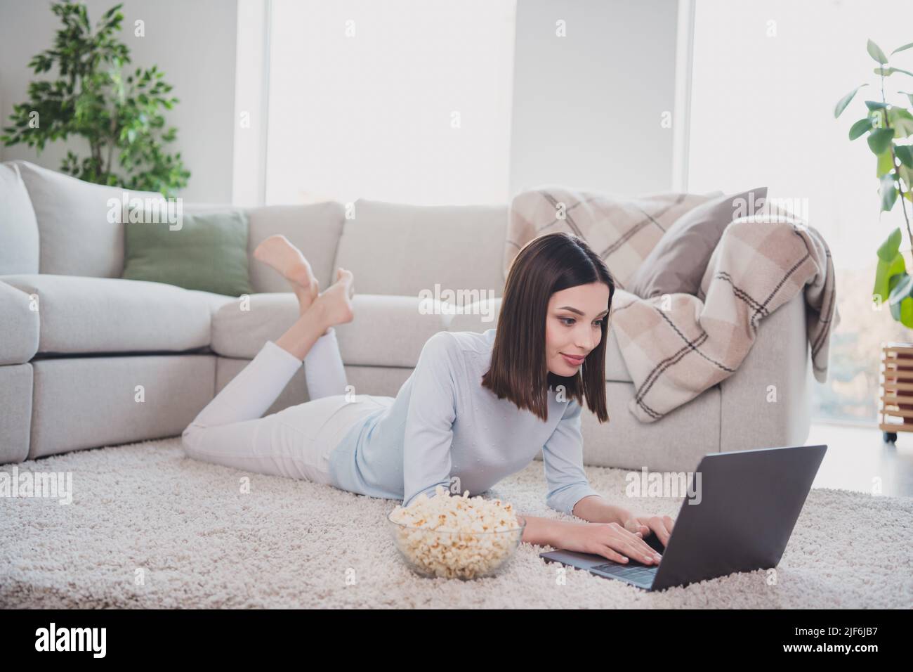 Full body photo of positive lady laying carpet floor use wireless ...